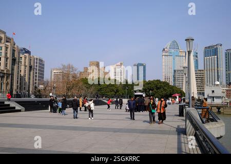 Pedestrians and tourists walking along the Bund in Shanghai, China ...