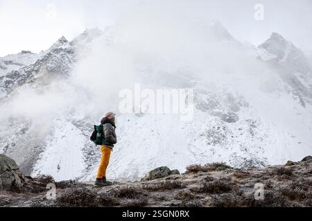 Female wears cold weather gear and headlamp while trekking Nepal Stock ...
