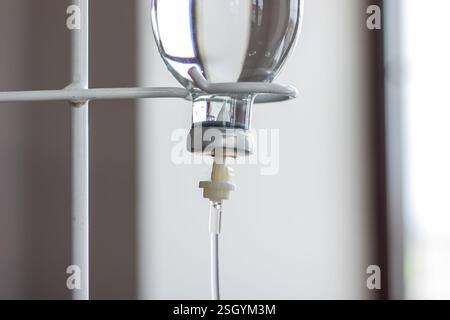 This is a detailed closeup image of an intravenous drip setup in a ...