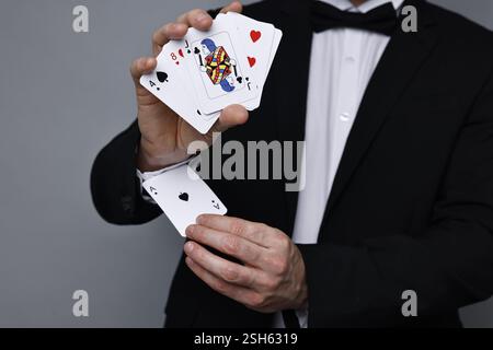 Illusionist hiding one playing card up his sleeve while showing deck on ...