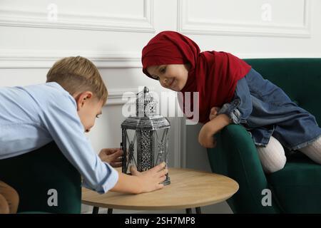 Muslim sister and brother spending time together at home Stock Photo ...