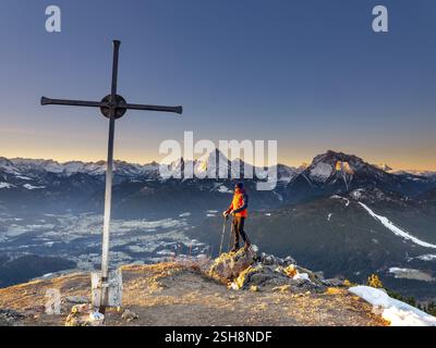 Mountaineers on the summit of Rauher Kopf at sunrise, behind them the ...