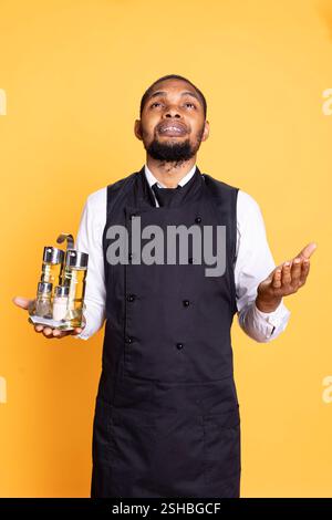 Spiritual waiter in apron praying to Jesus Christ with belief, being ...
