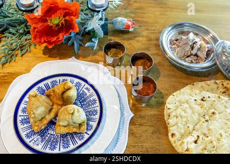 Samosas with various spices, saffron rice, naan bread and duck meat at ...