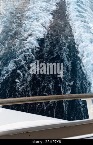 Idyllic view of wake in sea against cloudy sky Stock Photo - Alamy