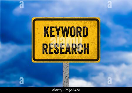 Keyword research message written on ripped torn orange paper with black ...