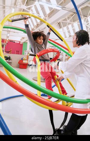 Girl having fun on gyroscope at science center Stock Photo - Alamy