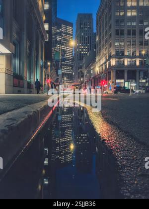 Scenic cityscape with buildings and streetlights reflecting on calm ...