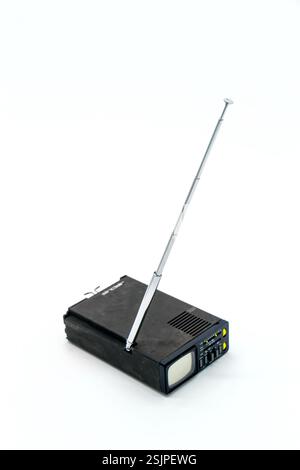 Vintage Sinclair portable television with an antenna against a plain ...