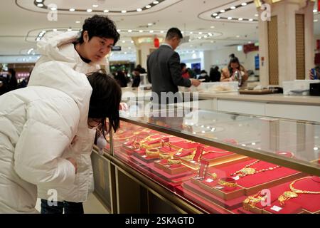 Consumers select gold jewelry at a store in Huai'an, east China's ...