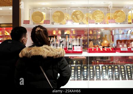 Consumers select gold jewelry at a store in Huai'an, east China's ...