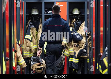 A firefighter walks past the fire scene at Wang Fuk Court, a ...