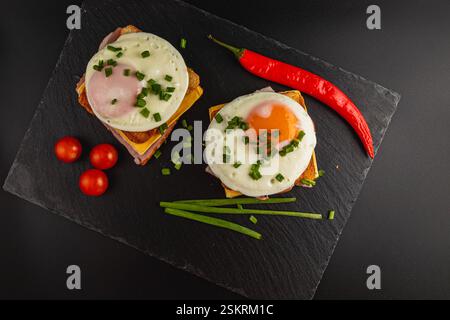 Slices of tasty ham, tomatoes, chili pepper and microgreen on table ...
