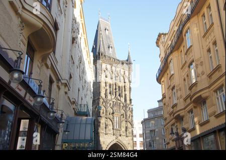 Gothic architecture dominates the narrow street, with a tall, pointed ...