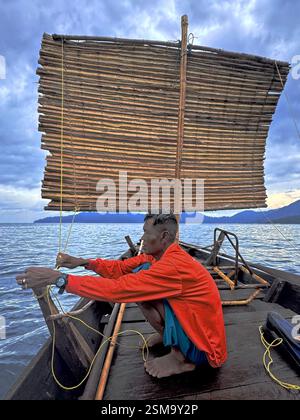 A Moken Sea Gypsy sails a traditional Moken Kabang boat in the waters ...
