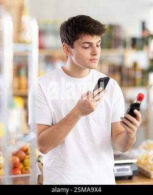 Guy buyer scans qr code on liquid detergent while shopping Stock Photo ...