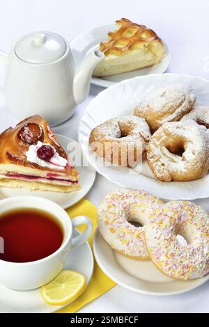 Still life of setout table with baking pies, donuts and tee cup . Image ...