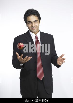 Maroon colour Cricket ball Stock Photo - Alamy