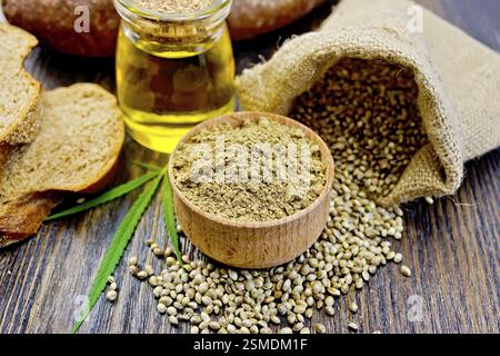 Hemp flour in wooden bowl, powder in spoon, cannabis leaves on the ...