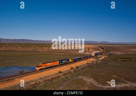 Aerial view of a freight train travelling through the outback region of ...