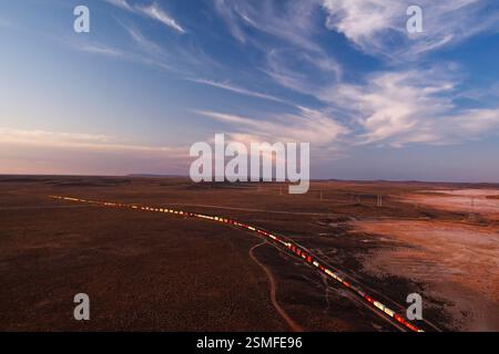 Aerial of shipping container intermodal freight train travelling ...
