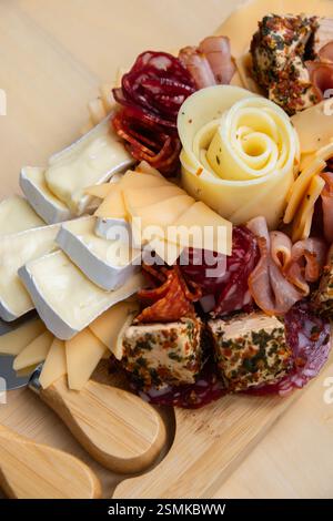 Special brie and blue cheese knives on a reddish wooden table Stock ...