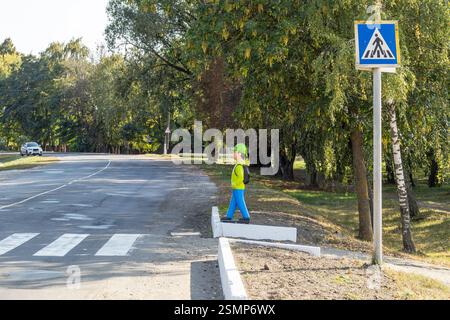A pedestrian crossing with a plastic child safety figure near a road ...