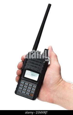 Handheld radio device held in a hand with a visible screen and antenna ...