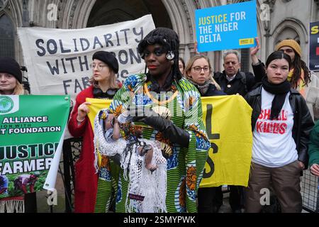 Activists stage an 'Ecocide Babe' stunt outside The Royal Courts Of ...