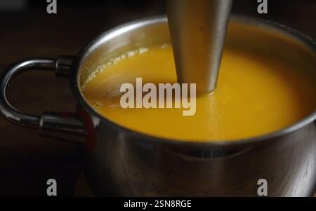 Cooking pumpkin soup. Blending with a blender Stock Photo - Alamy