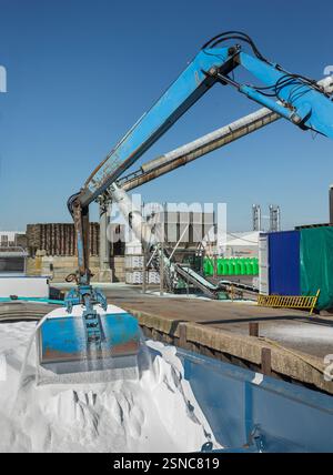 Unloading a ship with chalk. At a distribution and storage centre for ...