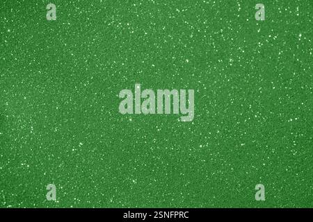 GREEN shimmering glitter material background with glowing effects and ...