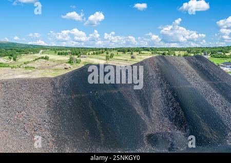 Slag mountains in the mining town of Roros, Norway. Slag is a by ...