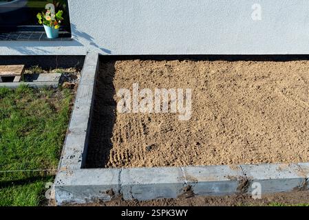 Sand bed prepared for compaction for construction of the terrace ...