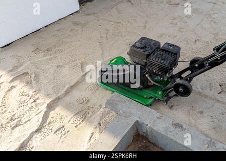 Compacted sand on a terrace under construction, using a gasoline ...