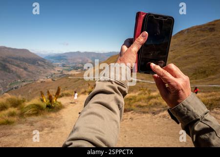 Queenstown, January 29th 2025: Tourists taking photographs on the road ...