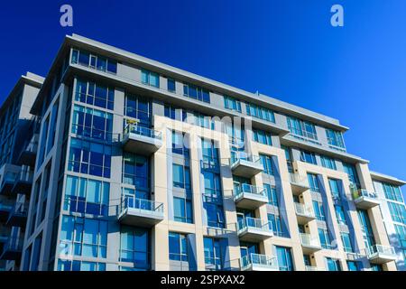 Low angle view of sleek glass building exterior with dark metal grid ...