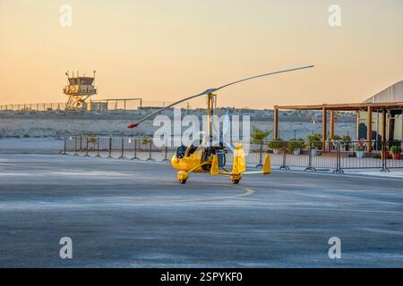 Small light helicopter Auto Gyro in yellow color on the ground. Super ...