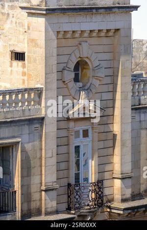 Traditional house detail in Malta. Limestone yellow bricks and colorful ...