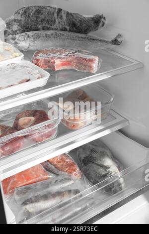 Different frozen meat and fish products in fridge, closeup Stock Photo ...