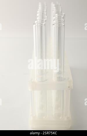 Empty test tubes on light colorful background Stock Photo - Alamy