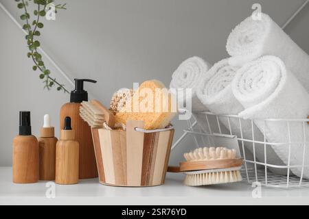 Set of bathing supplies on table against beige background. Banner for ...