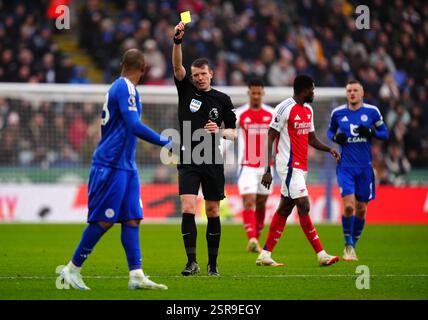 Referee Sam Barrott shows a yellow card to Leicester City's Kasey ...