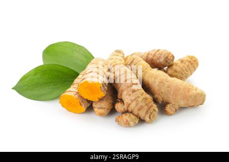 Raw turmeric roots and green leaves isolated on white Stock Photo - Alamy