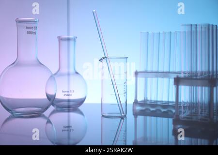Laboratory glassware on mirror surface against light background Stock ...