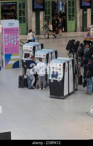 Rail passengers using a ticket machine / ticket vending machine / TVM ...
