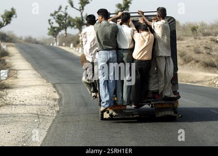 Passengers travelling on footstep of jeep, Rajasthan, India, Asia Stock ...