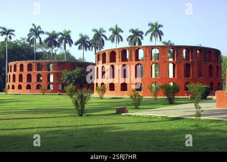 Two circular red structures of Jantar Mantar date trees in background ...