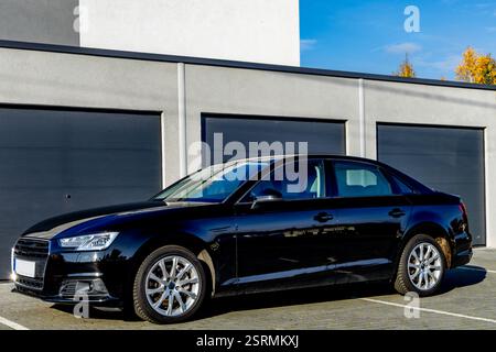 Black limousine, luxury sedan parked in front of the garage, car waxing ...