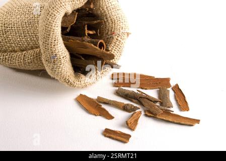 Spices, cinnamon in jute sack spread on white background Stock Photo ...